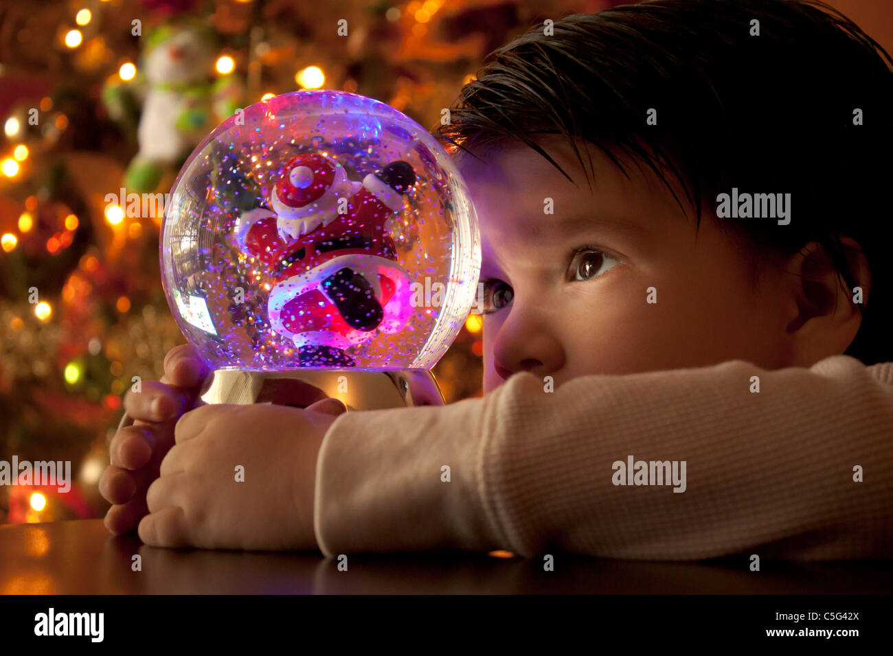 Child looking at Santa in a snow ball Stock Photo - Alamy