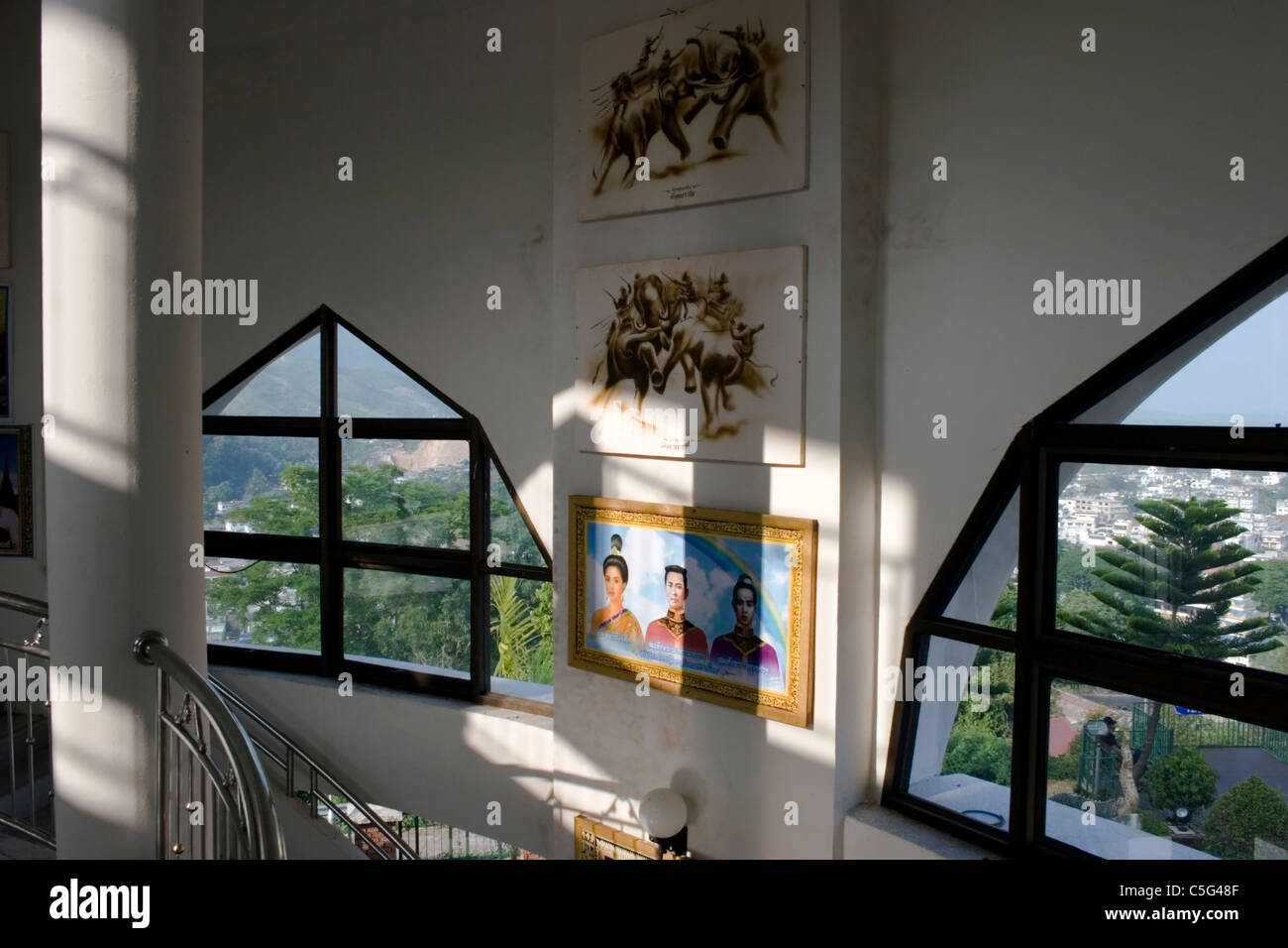 Wall paintings line a circular staircase at a beautiful Buddhist temple ...