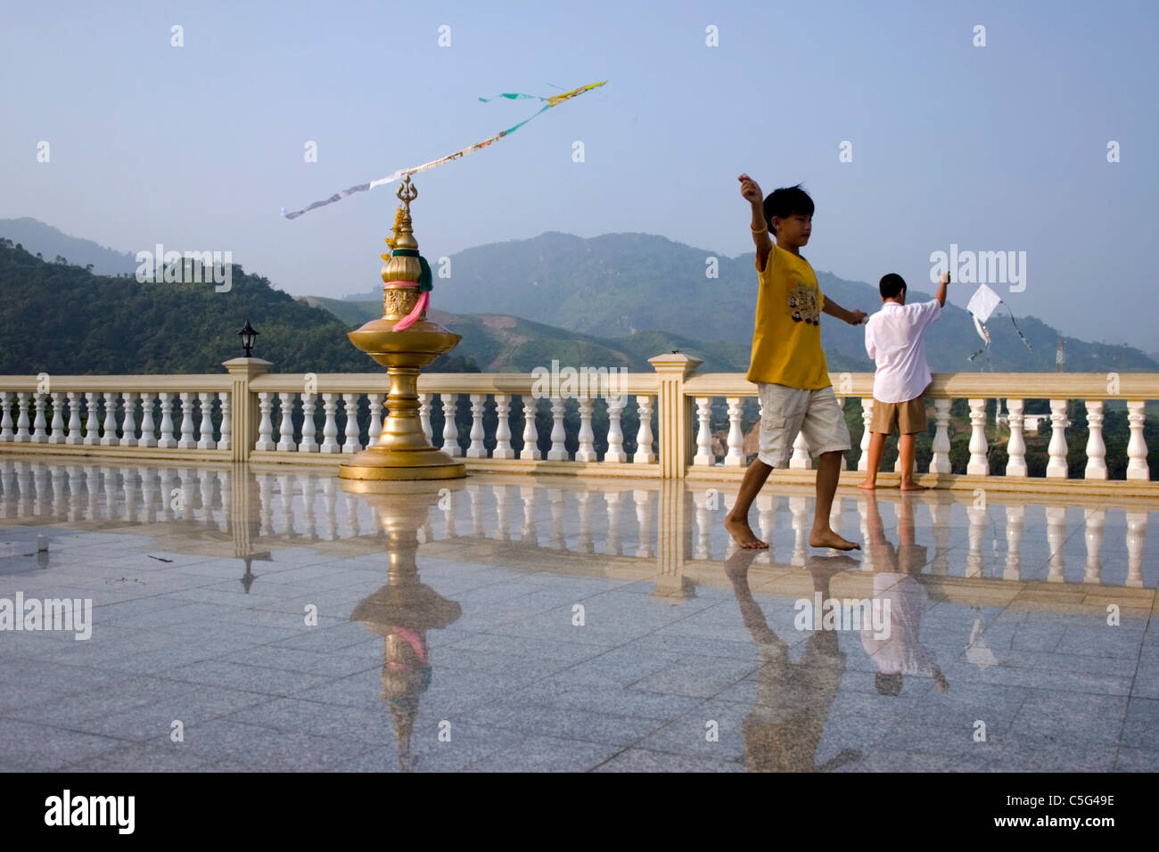 Young boys are flying kites on an observation deck that overlooks Burma ...