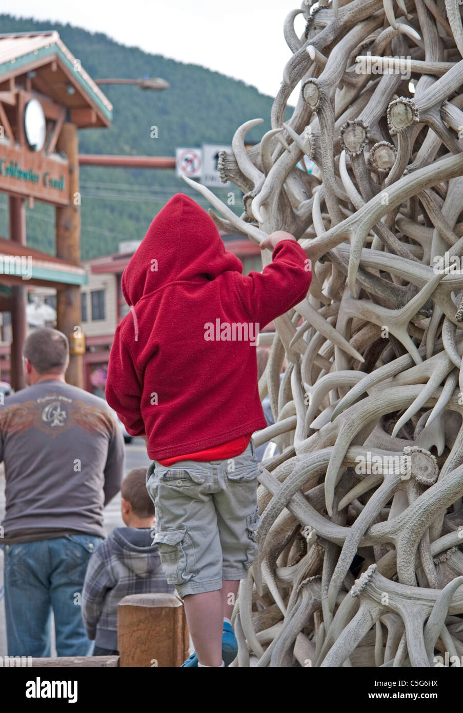 A young child exploring Jackson Hole's unusual Antler Gate Stock Photo ...