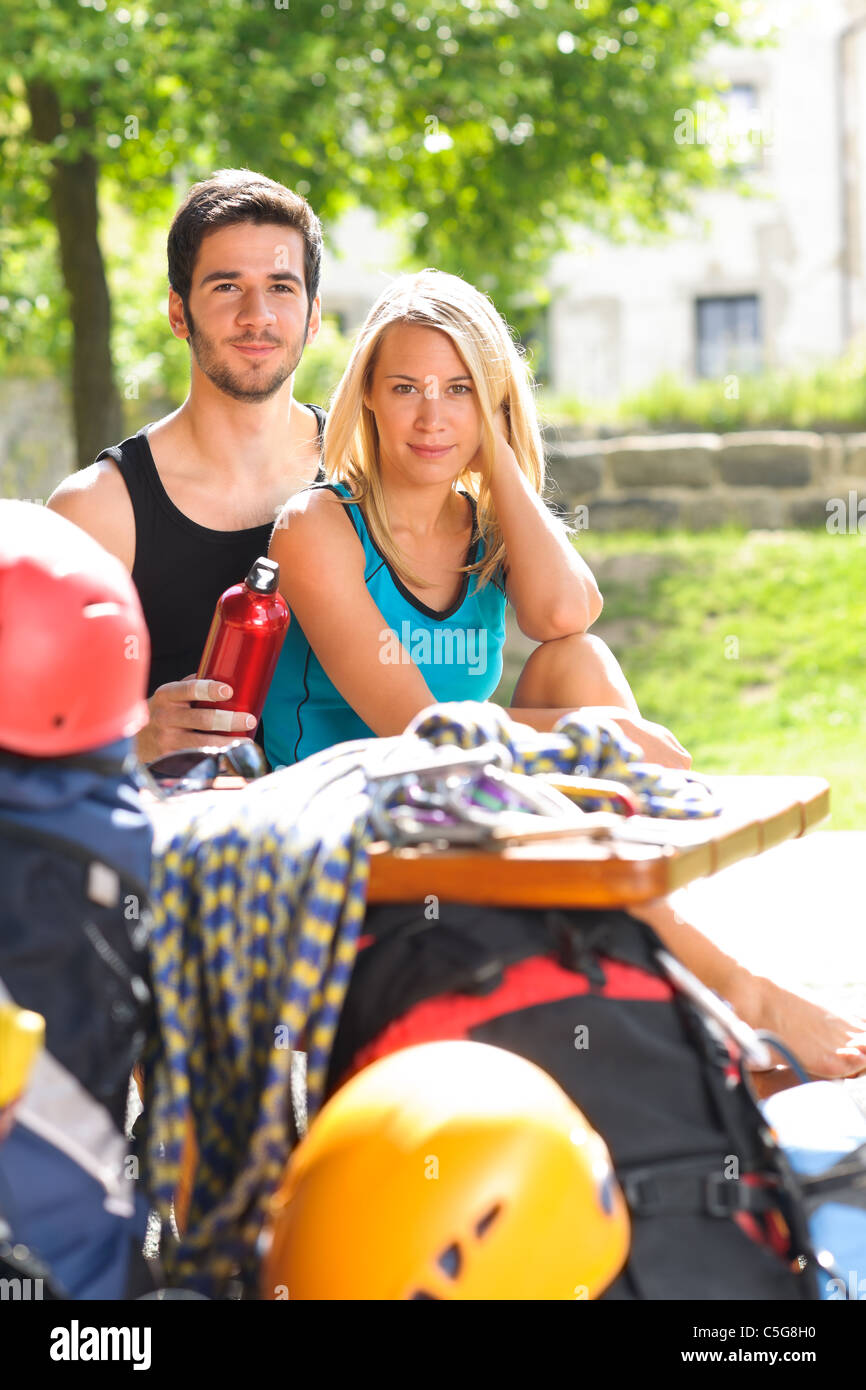 Backpack active young couple relax with climbing gear sunny terrace ...