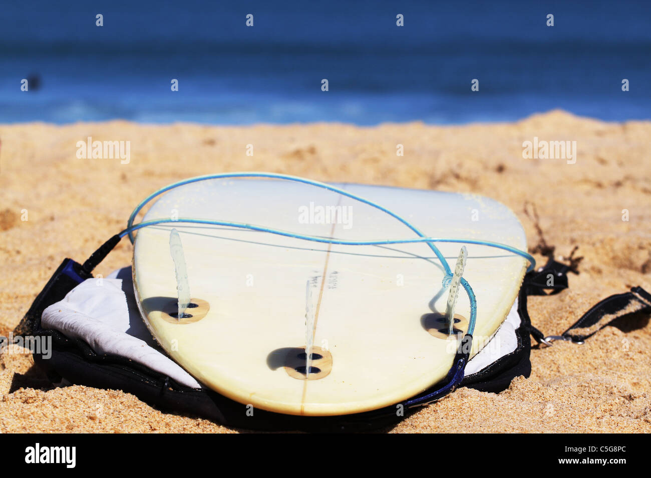 Surfboard lying on beach Stock Photo - Alamy