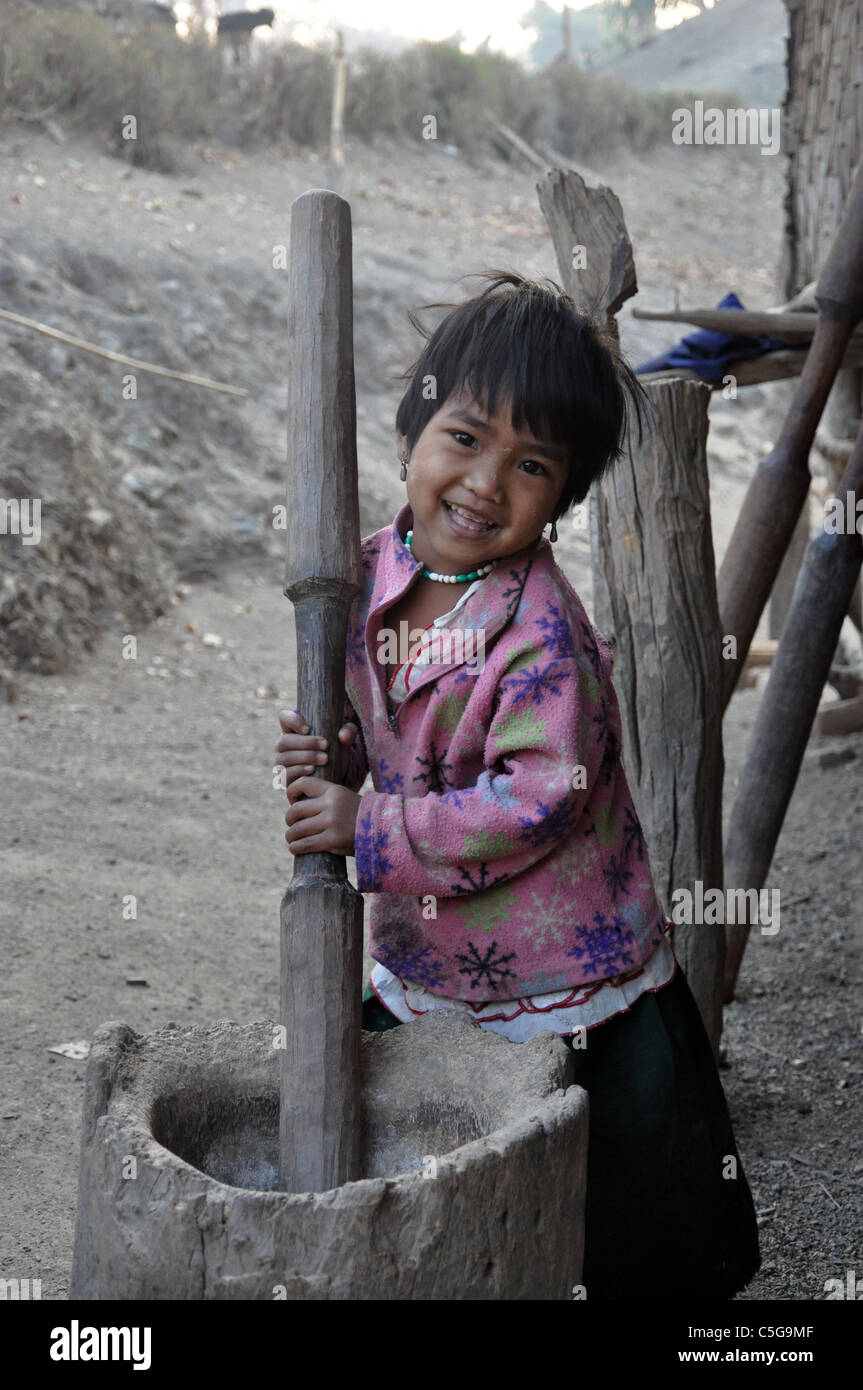 Ethnic Chin girl doing traditional rice pounding from Chin State ...