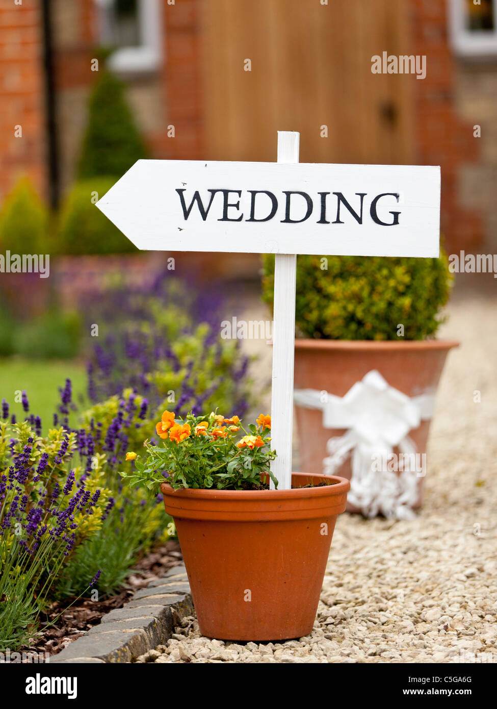 A signpost with 'wedding' written on it in a flowerpot Stock Photo - Alamy