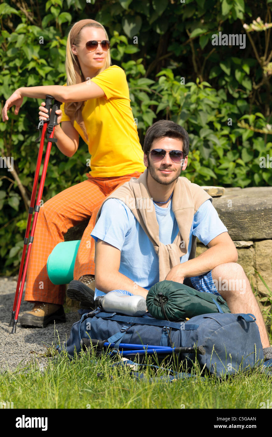 Hiking young couple with poles relax outside summer day Stock Photo - Alamy