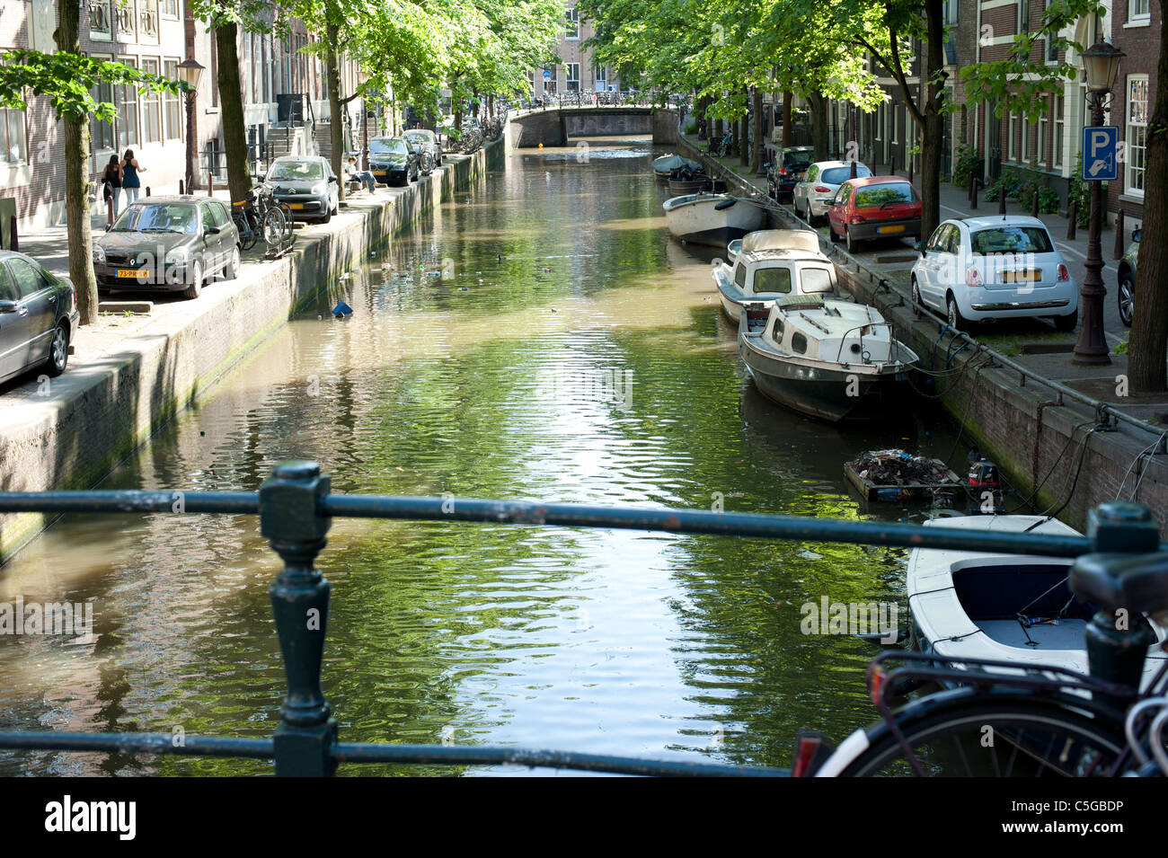 Typical Amsterdam scene of a canal with boats Stock Photo - Alamy