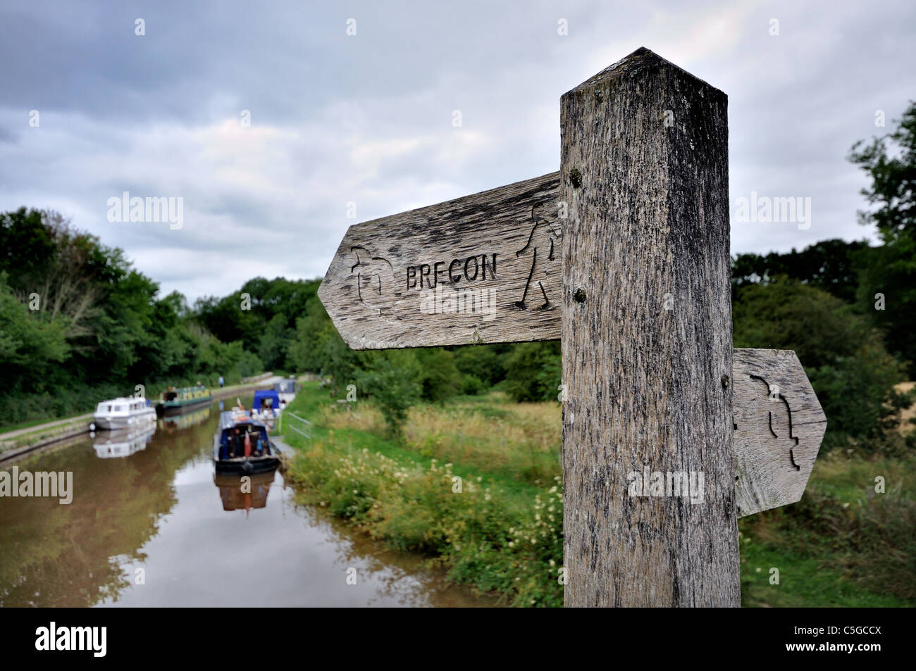Footpath sign and narrowboats on the Monmouthshire & Brecon Canal Stock ...