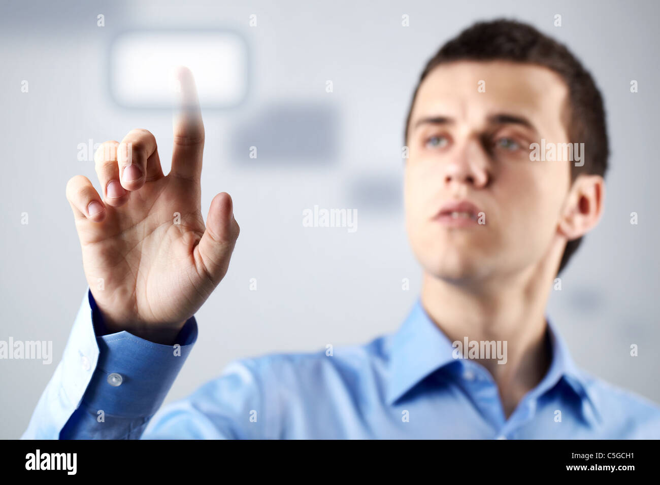 Confident businessman pressing button Stock Photo - Alamy