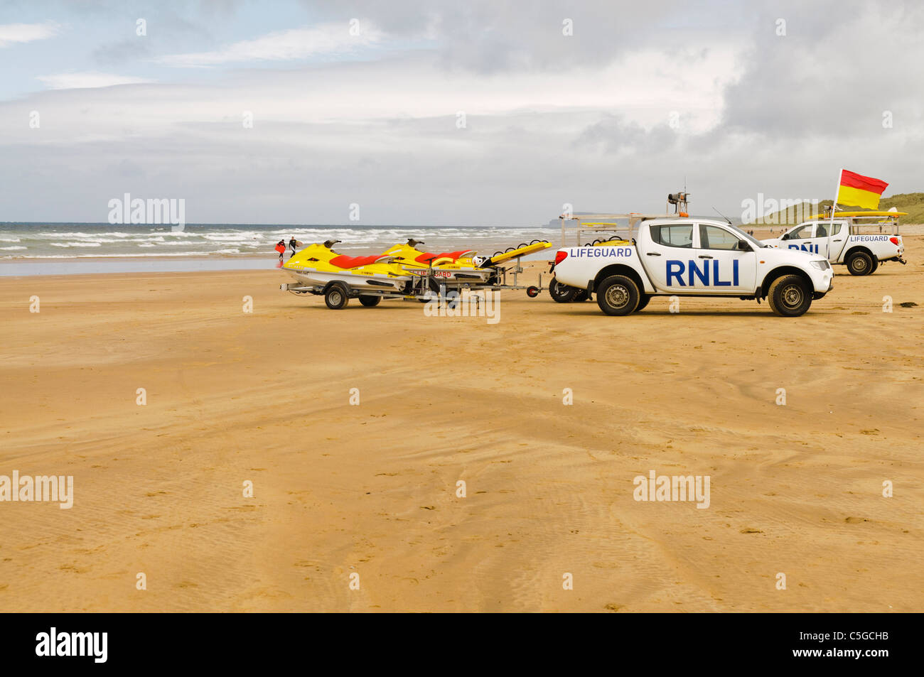 RNLI Lifeguard vehicle and jetski at the East Strand, Portrush Stock ...