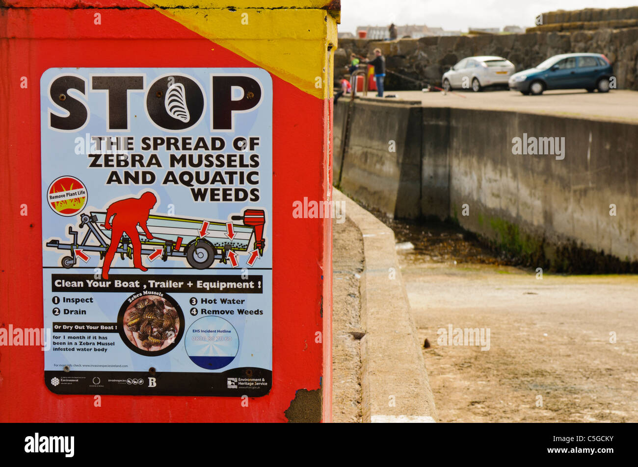 Sign on a harbour slipway warning people of the spread of Zebra mussels ...