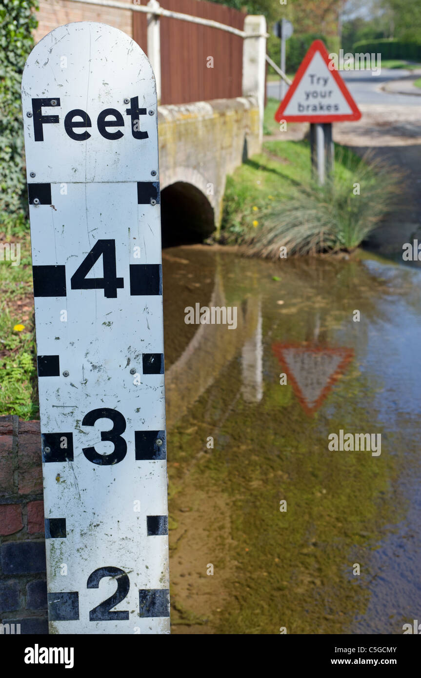 Depth marker showing the water level in a village ford Stock Photo - Alamy