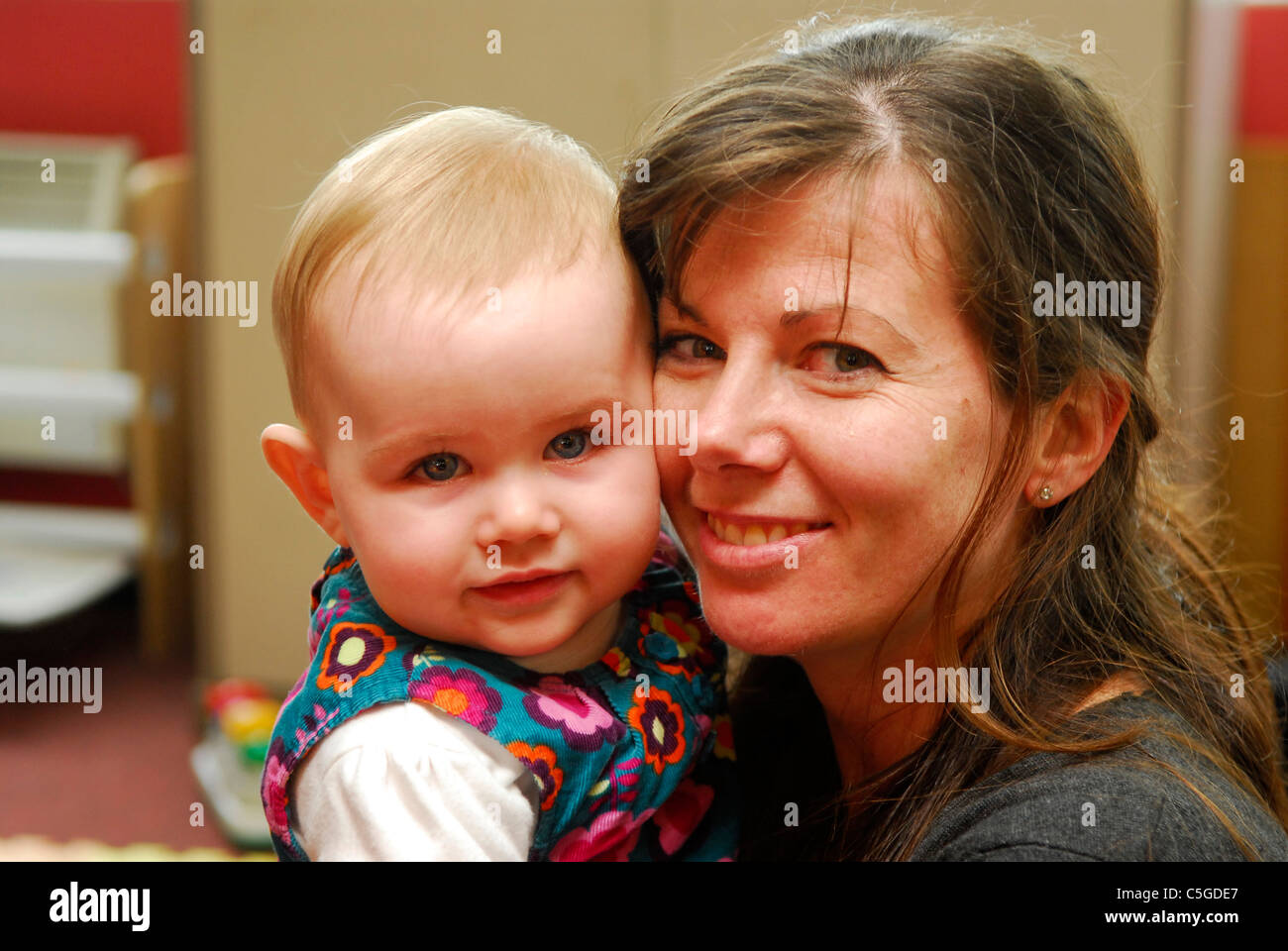 Mother with her baby in creche, Surrey, UK Stock Photo - Alamy