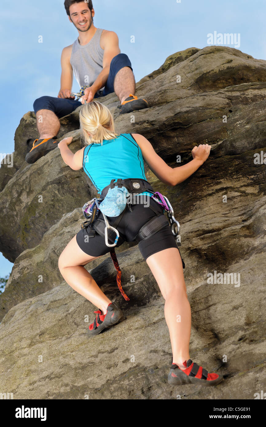 Rock climbing active young woman man holding rope on top Stock Photo ...