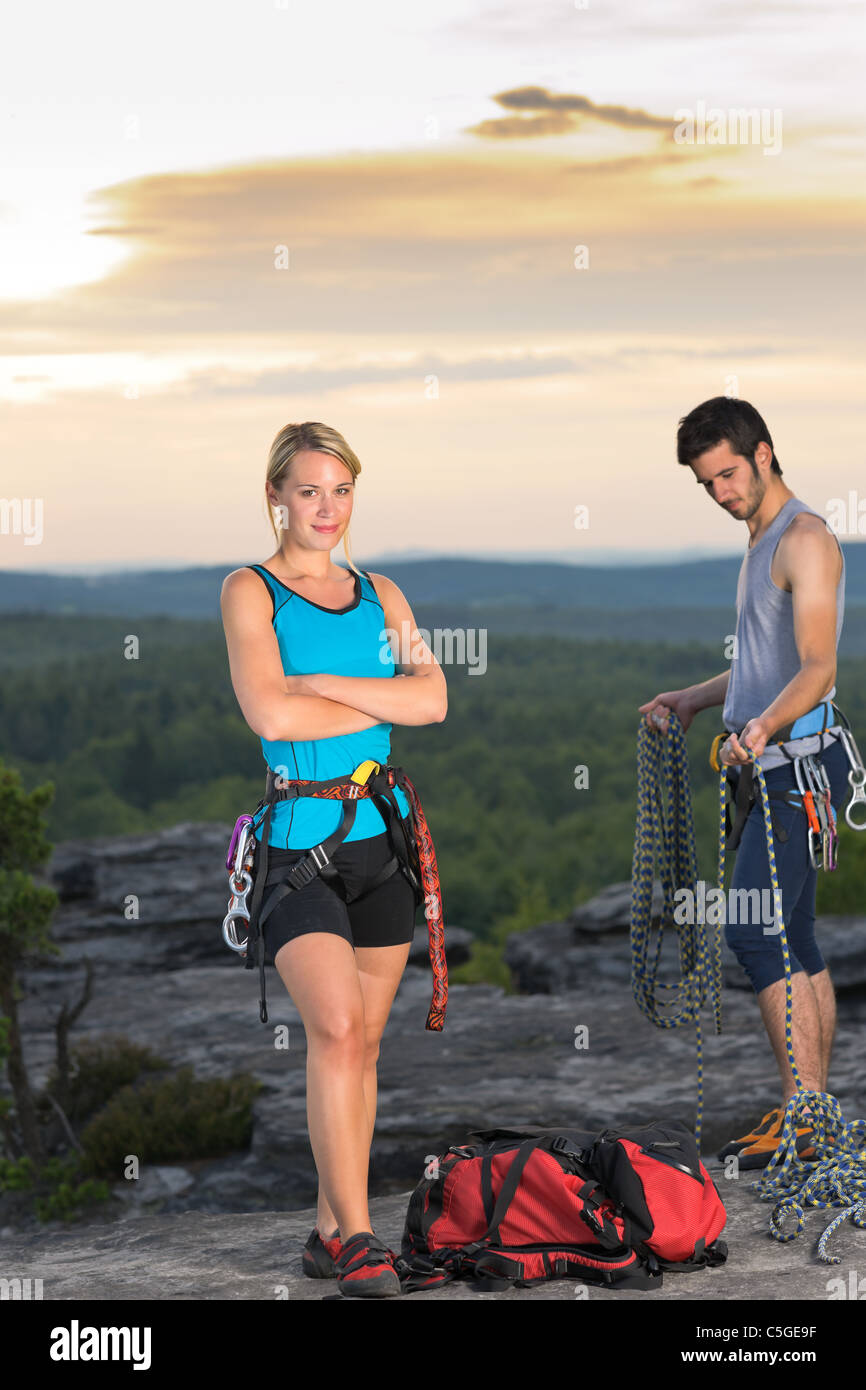 Active young couple rock climbing reach top at sunset Stock Photo - Alamy