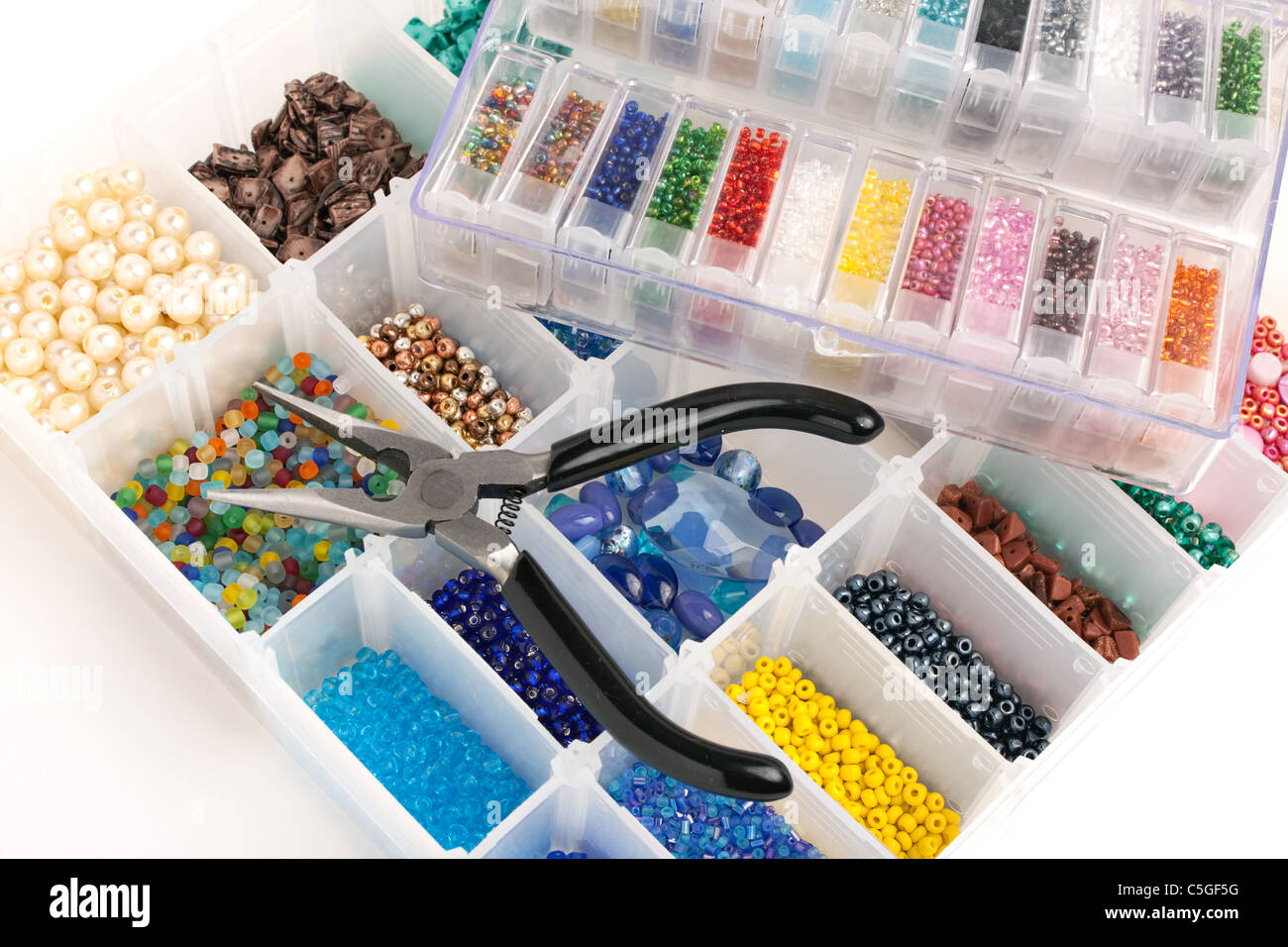 An organizer full of multi colored beads and tools for making jewelry ...