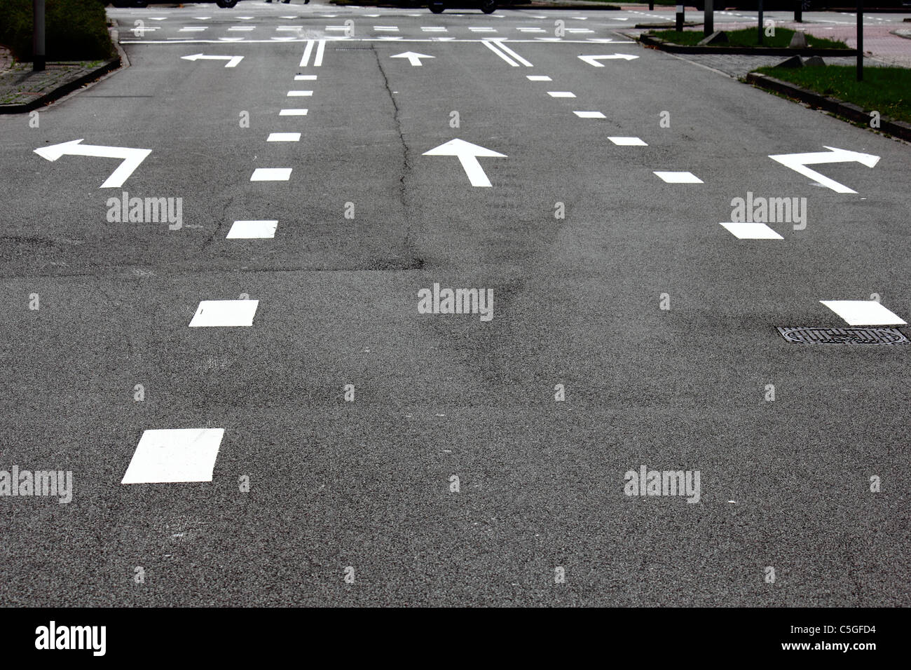 traffic arrows on the street at a intersection , conceptual image ...