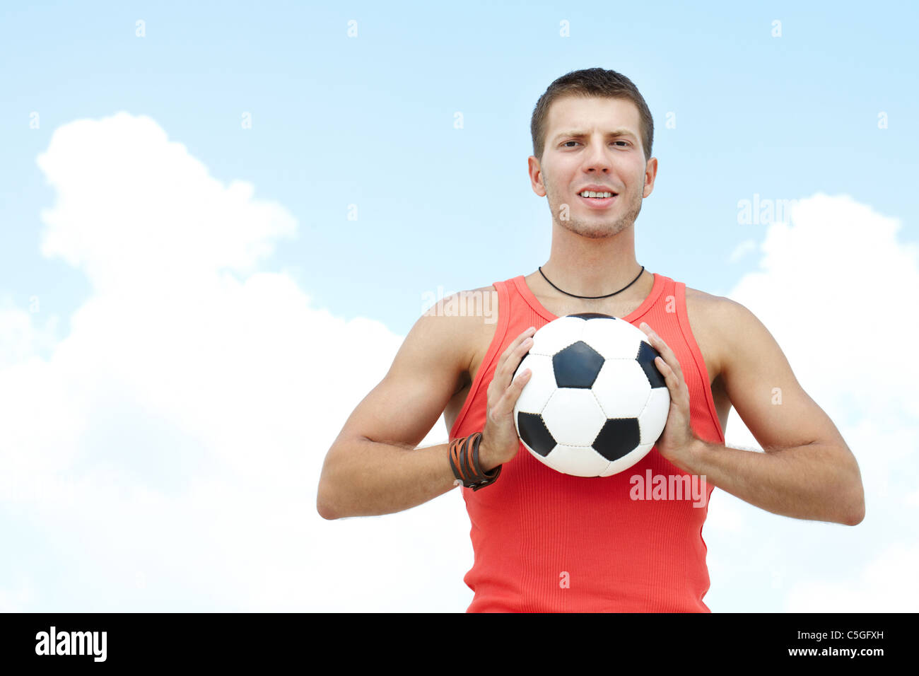Portrait of a young man holding football ball Stock Photo - Alamy