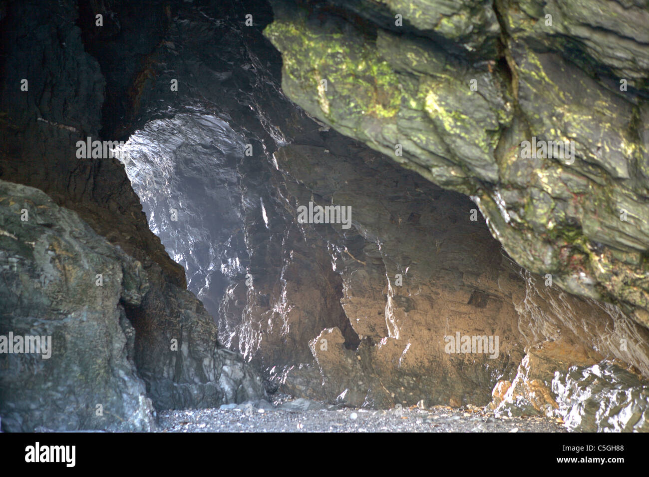 Inside Merlins Cave beneath Arthurs castle at Tintagel, looking ...