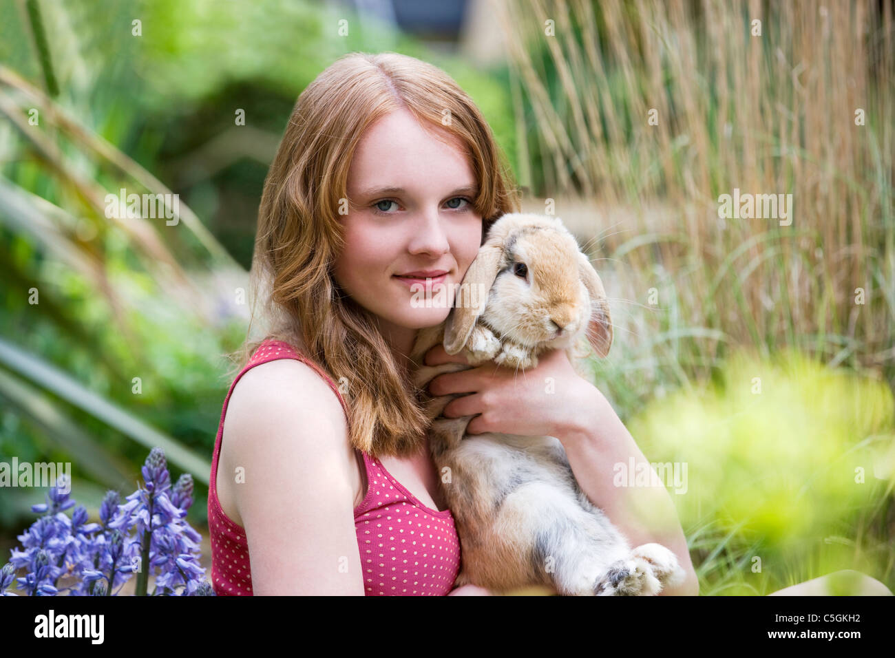 A young girl holding her pet rabbit Stock Photo - Alamy