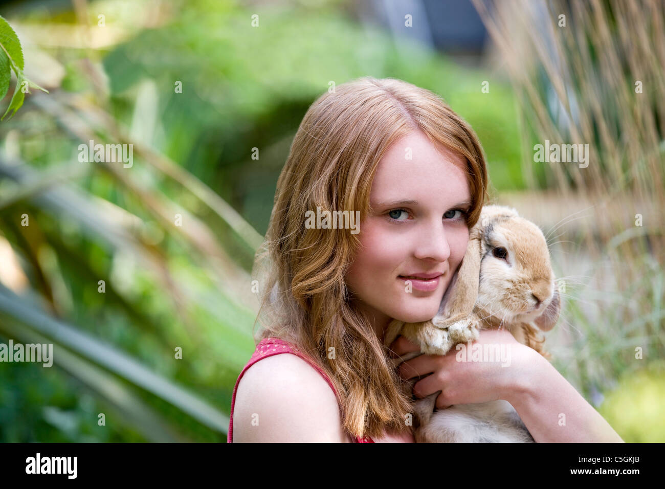A young girl holding her pet rabbit Stock Photo - Alamy