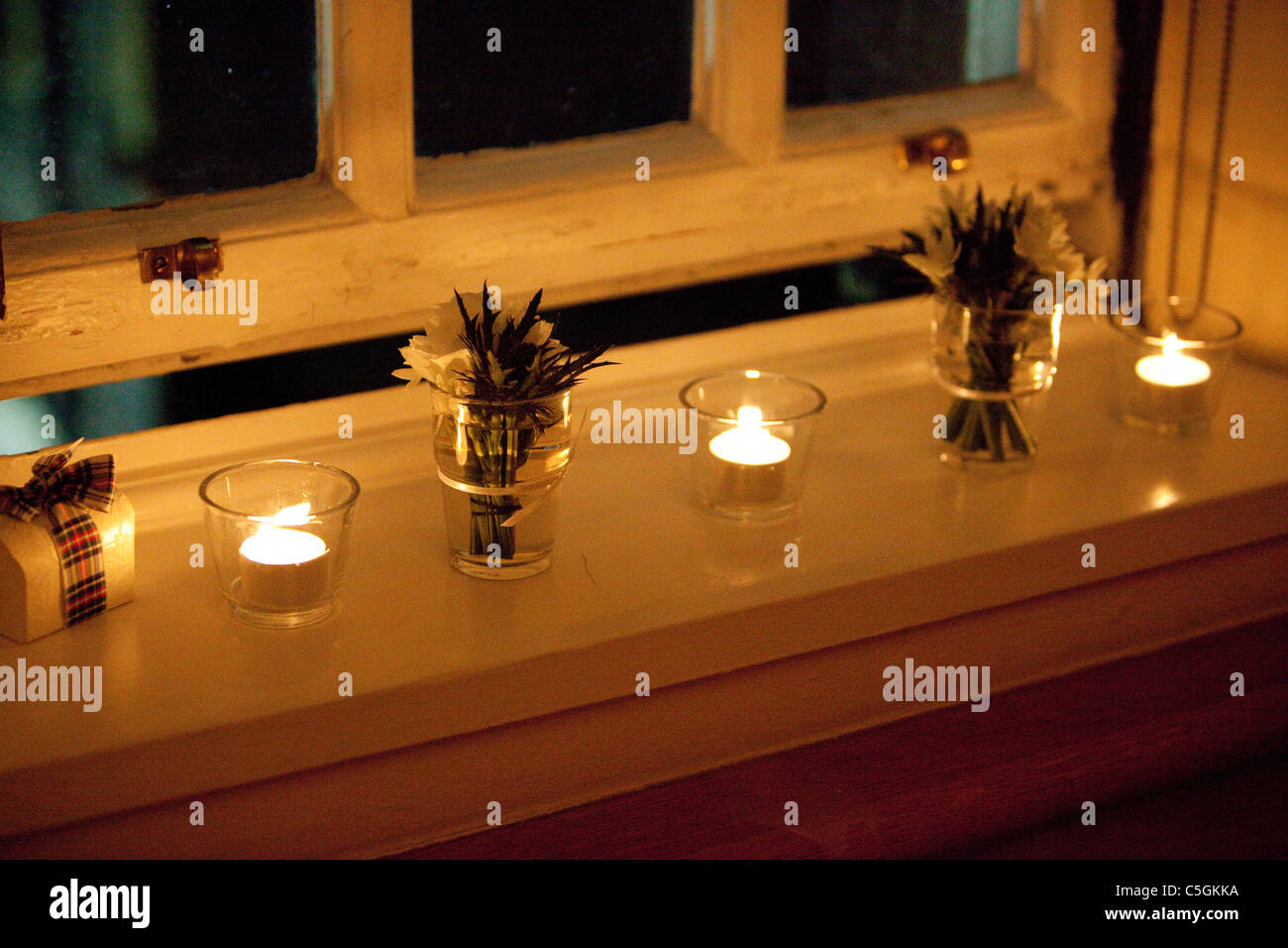 Candle on the window sill at Edinburgh Castle, with flowers Stock Photo ...