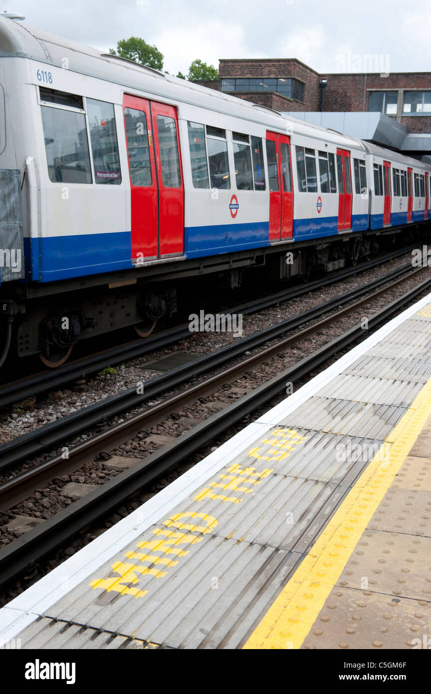 London Underground tube train traveling overground on the Metropolitan ...