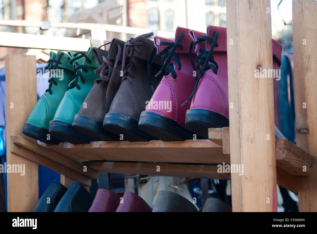 Heels of a row of boots on a rack on a stall in a market in Cambridge ...