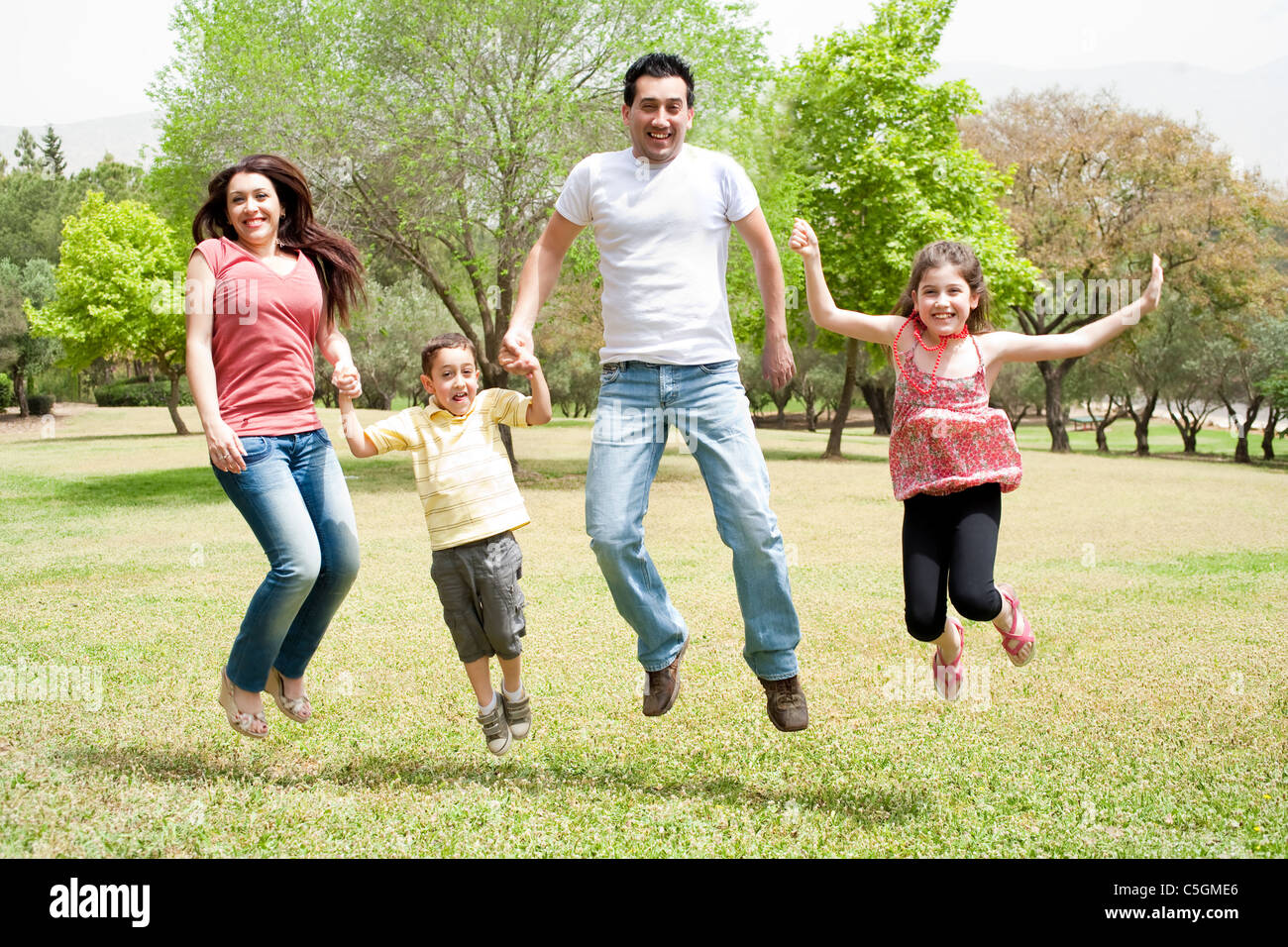 Family jumping together in the park,outdoor Stock Photo - Alamy