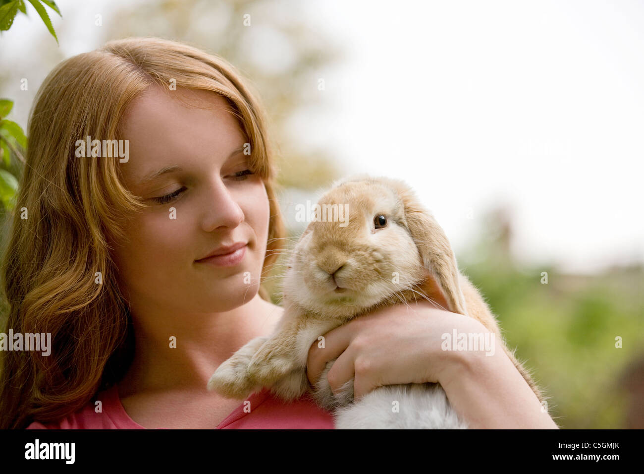 A young girl holding her pet rabbit Stock Photo - Alamy