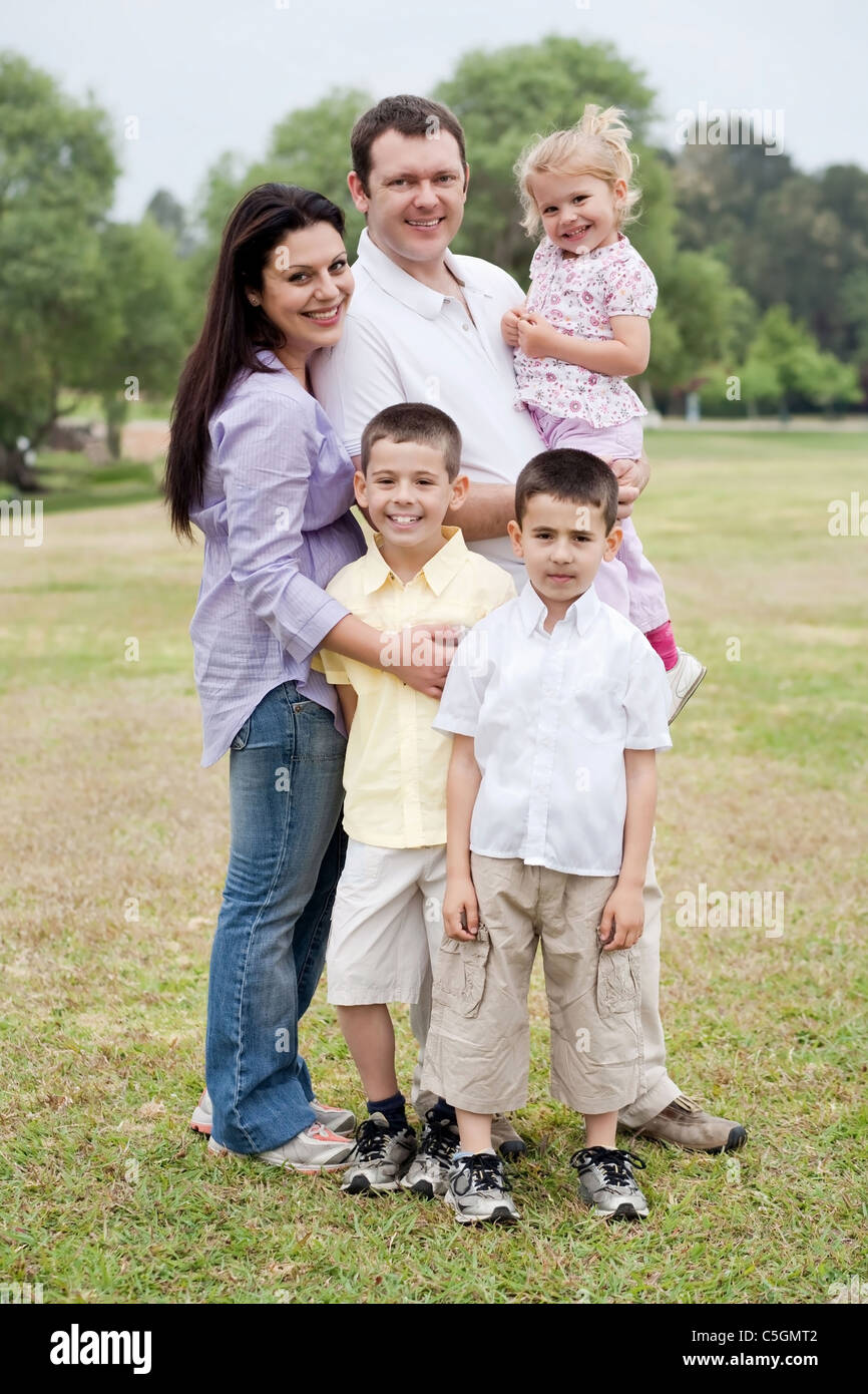 Happy family of five posing on natural background Stock Photo - Alamy