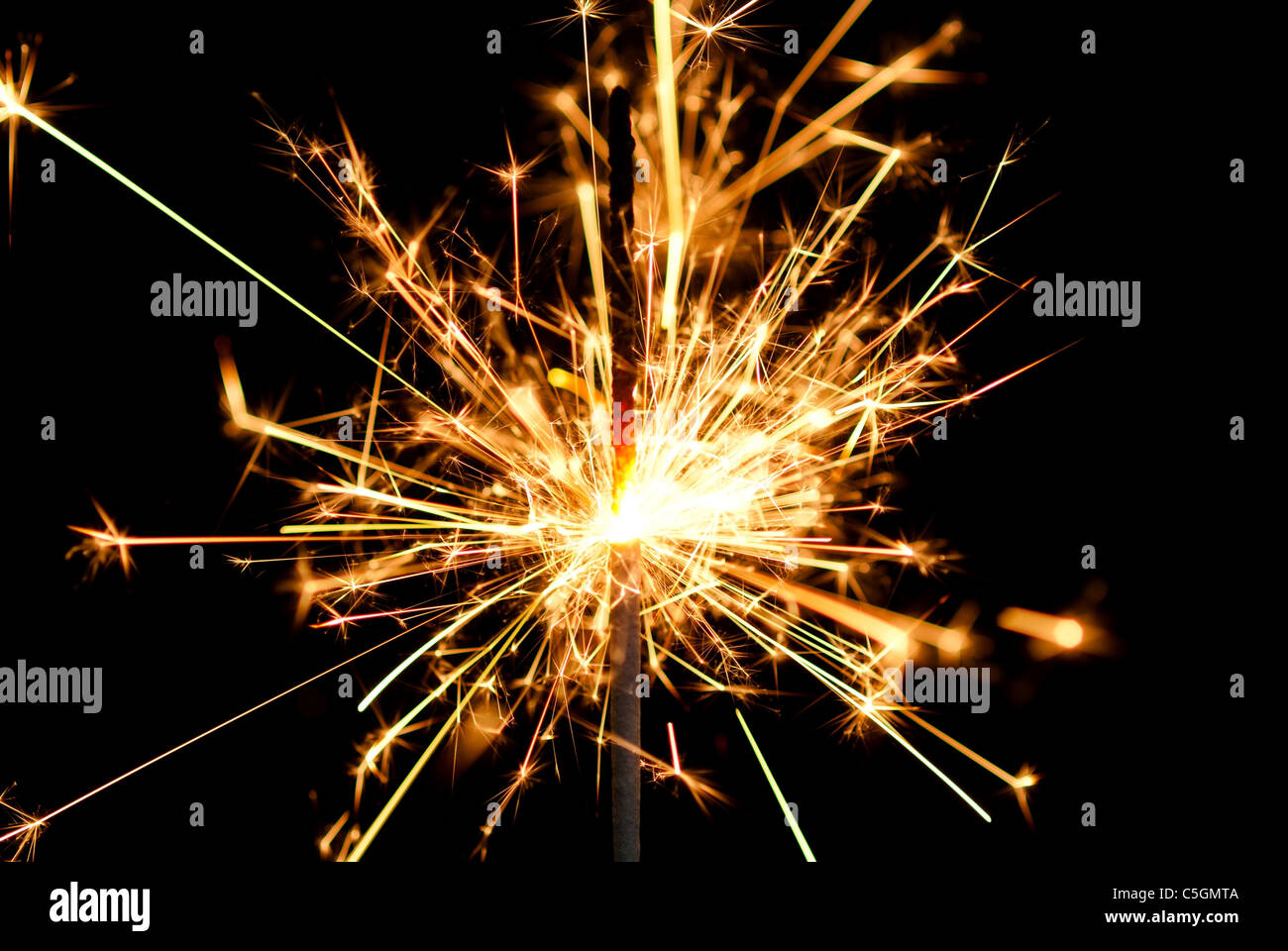 a burning sparkler before black background Stock Photo - Alamy