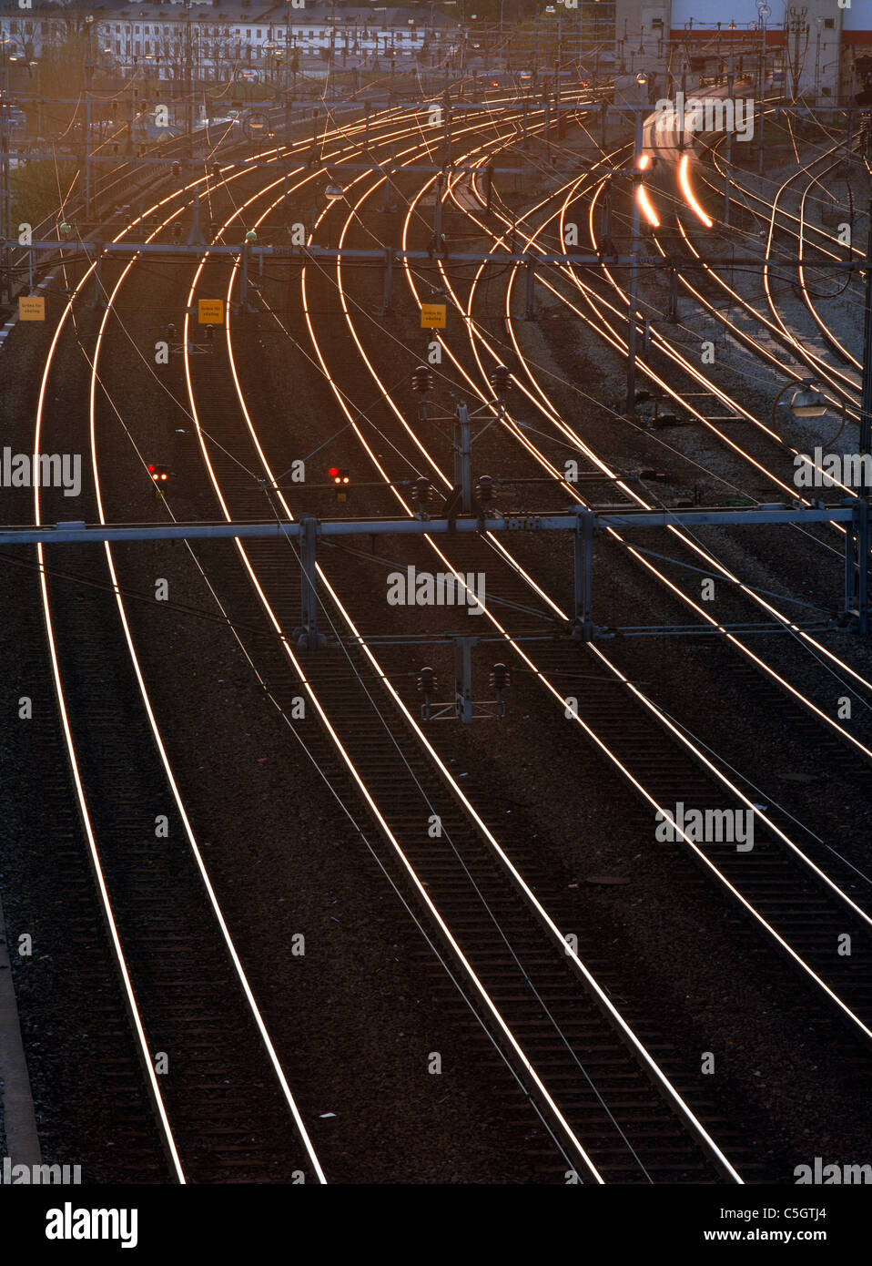 Pairs of rails reflecting sunset light at Stockholm central train ...