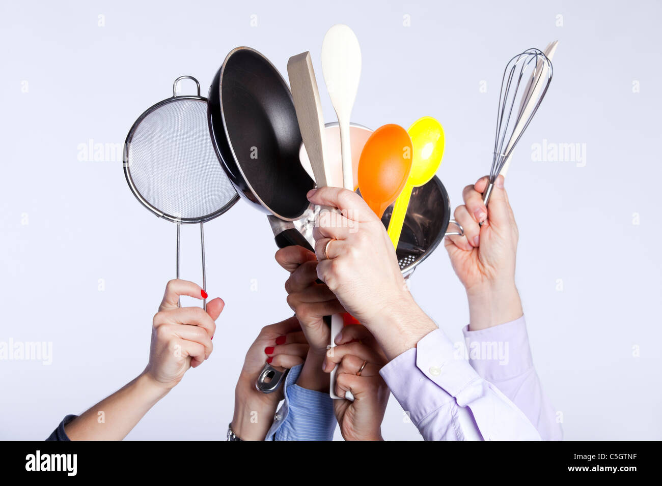 Group of people hands holding some kitchenware tools (selective focus ...