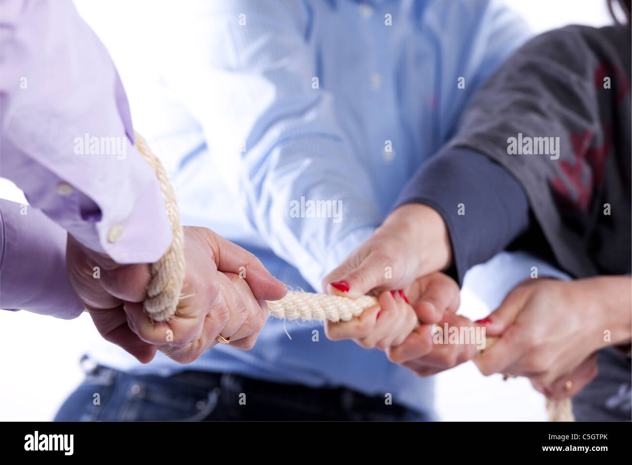 Group of woman hands pulling a rope competing with a man (selective ...