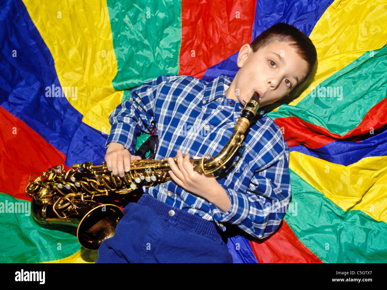Young boy playing the saxophone Stock Photo - Alamy