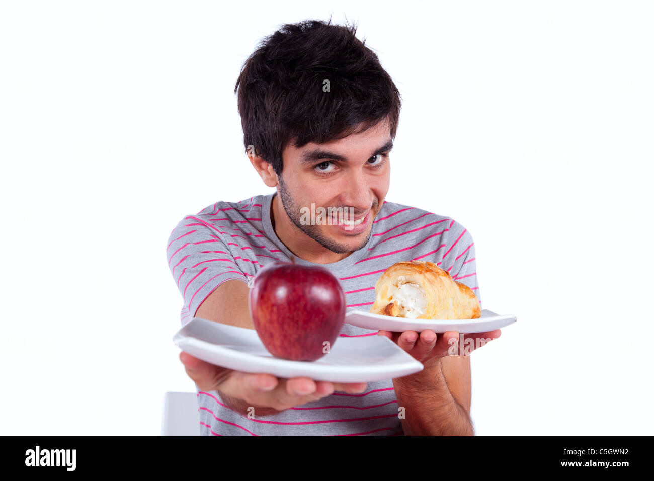 man thinking what to eat between an apple and a cake (isolated on white ...