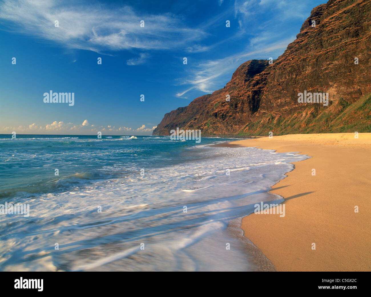 Shadows from couple on wave washing over beach at Polihale on Island of ...