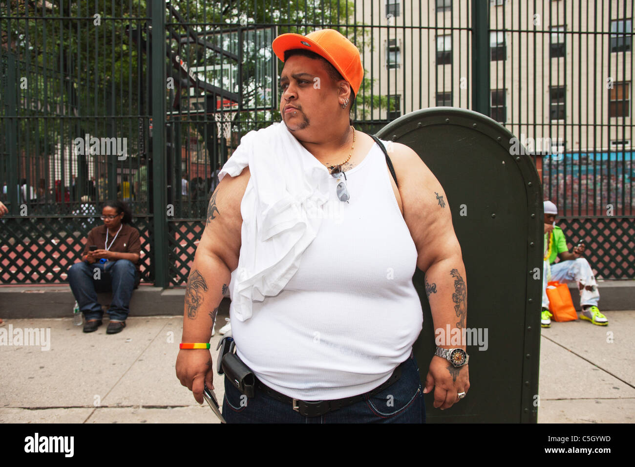 An overweight gay female stands alone after the Gay Pride Parade in New ...