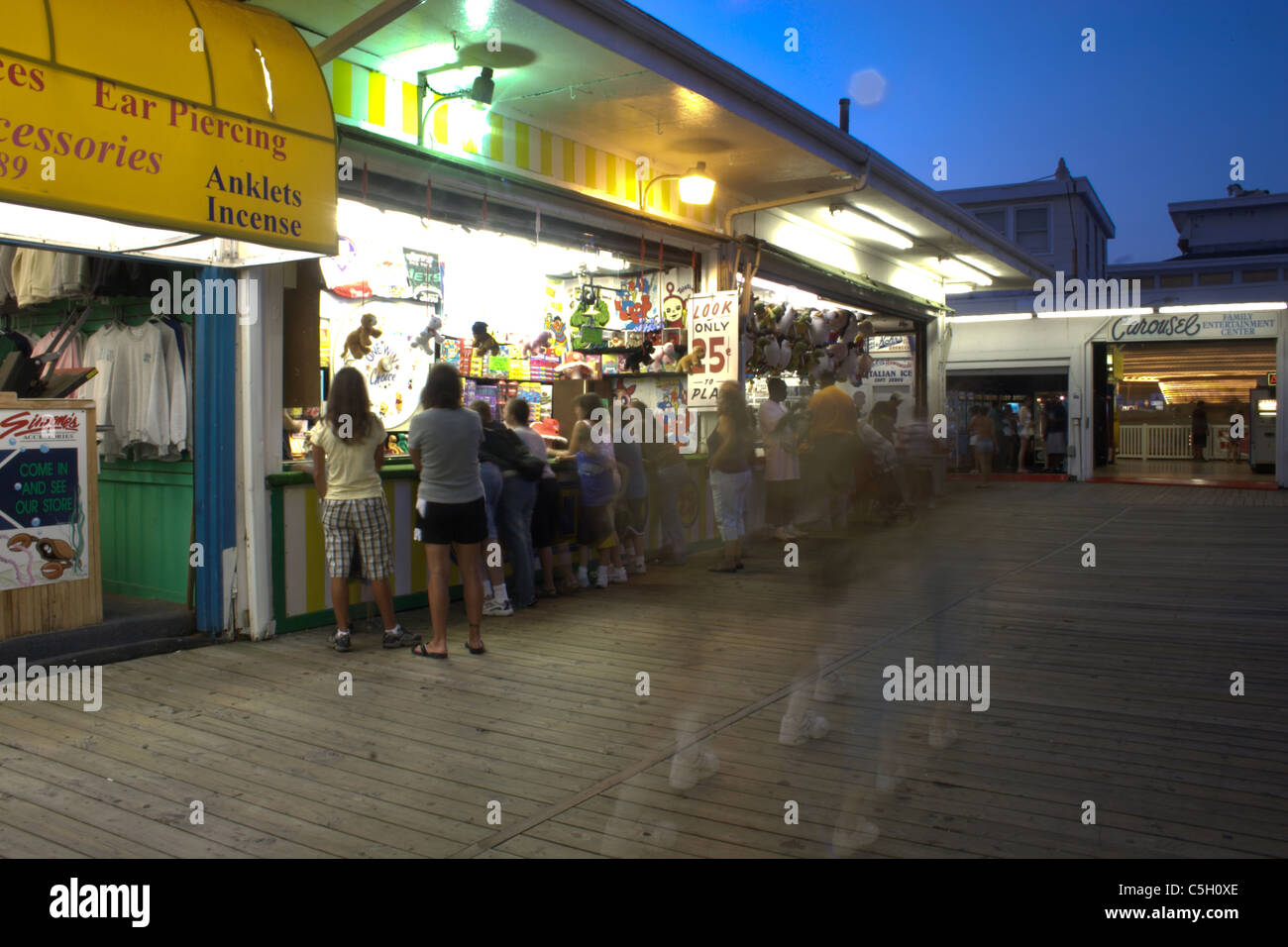 Fair at night, on a boardwalk Stock Photo - Alamy