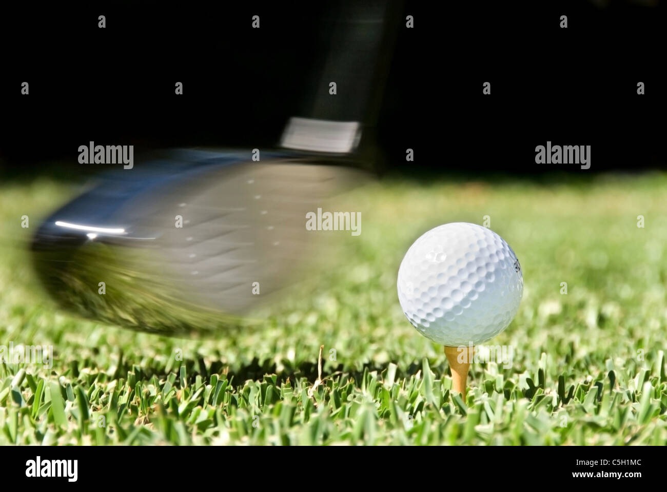Golf club being swung at golf ball during a competition Stock Photo - Alamy