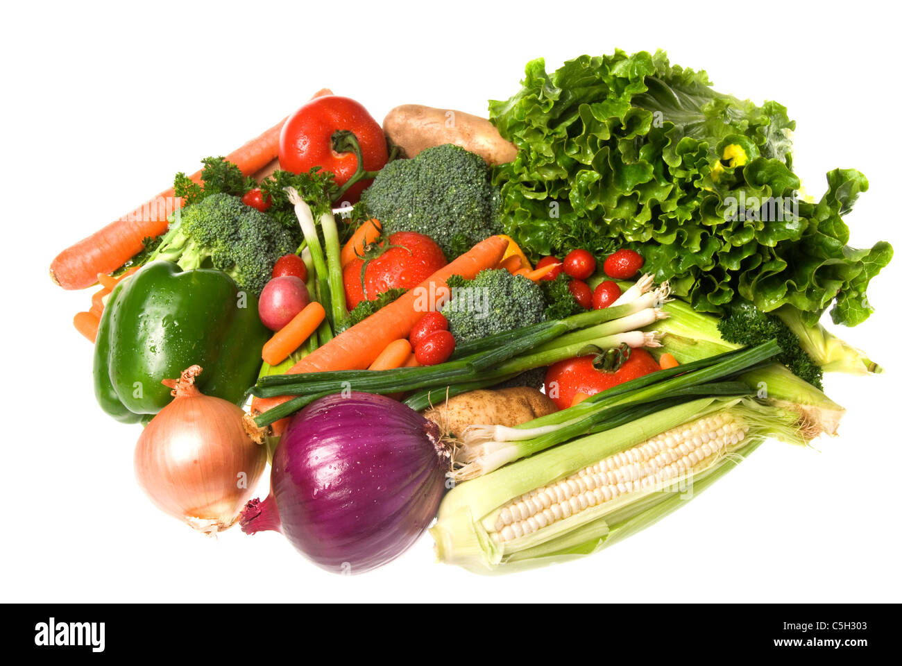 A vibrant assortment of fresh vegetables isolated on a white background ...
