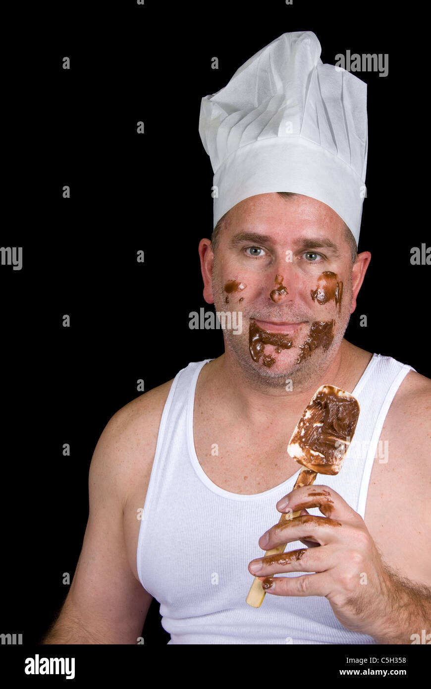A pastry chef shows off his spatula and filthy look Stock Photo - Alamy