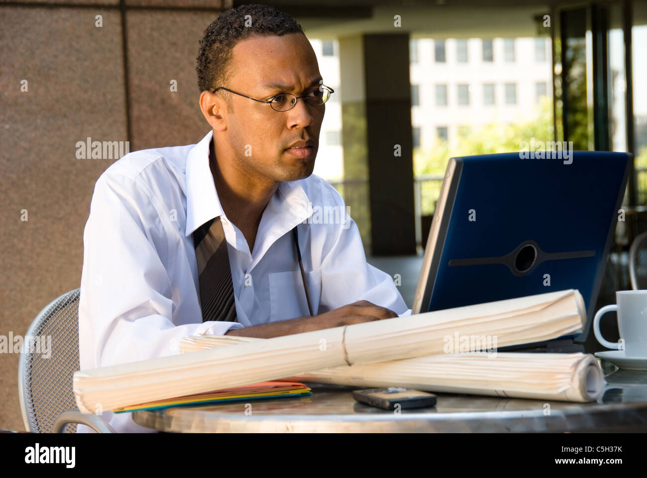 An executive engineer conducting work during his lunch hour Stock Photo ...
