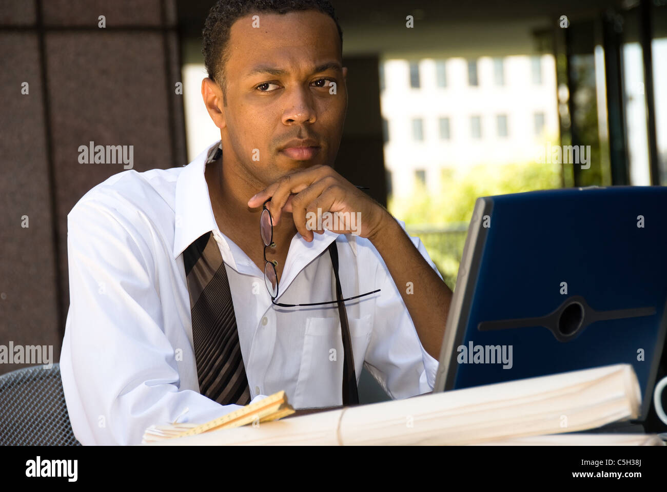 An executive engineer conducting work during his lunch hour Stock Photo ...