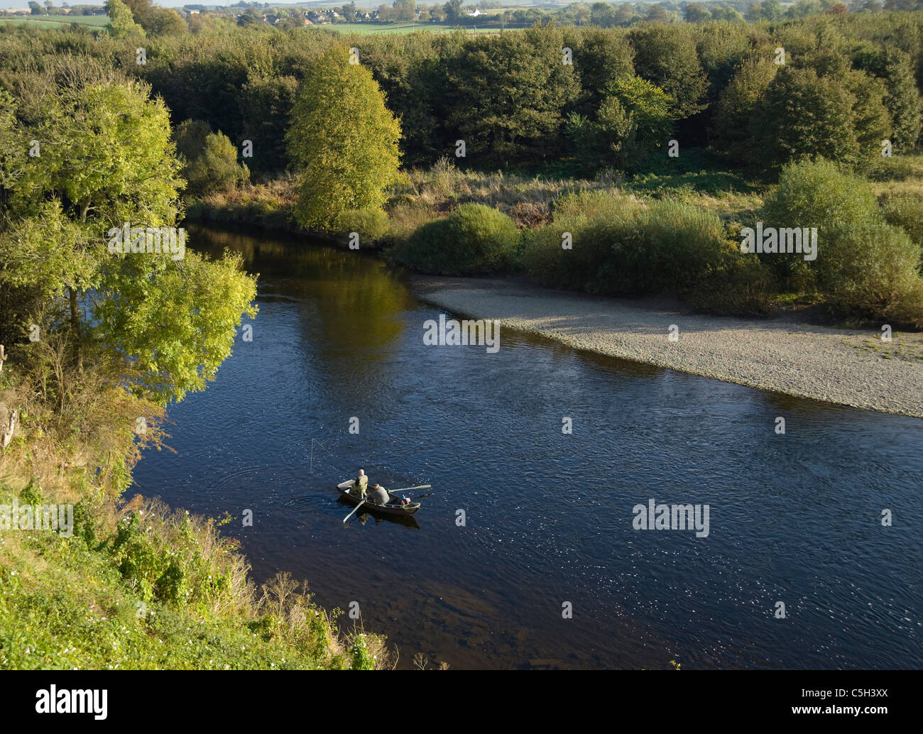 River Tweed and fly fisherman in rowing boat near Coldstream Stock ...