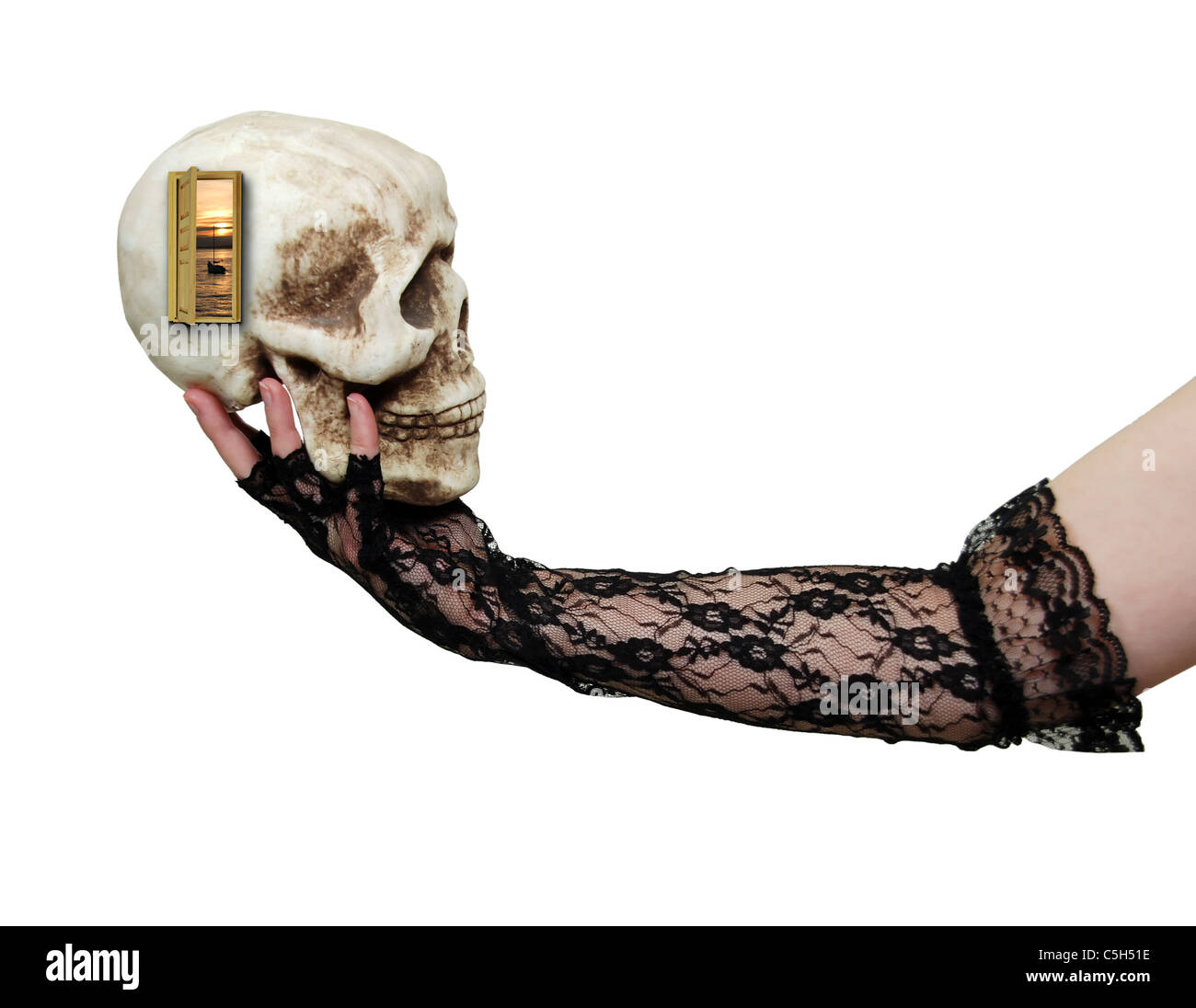 Wearing lace gloves with a delicate pattern holding a skull with a ...