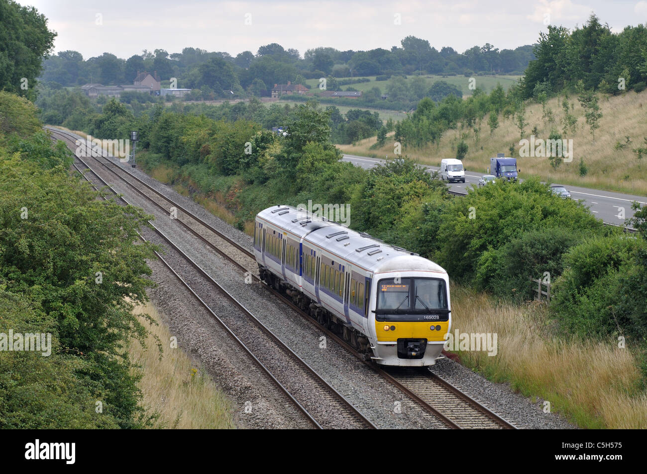 Chiltern Railways train on a line alongside the M40 motorway ...