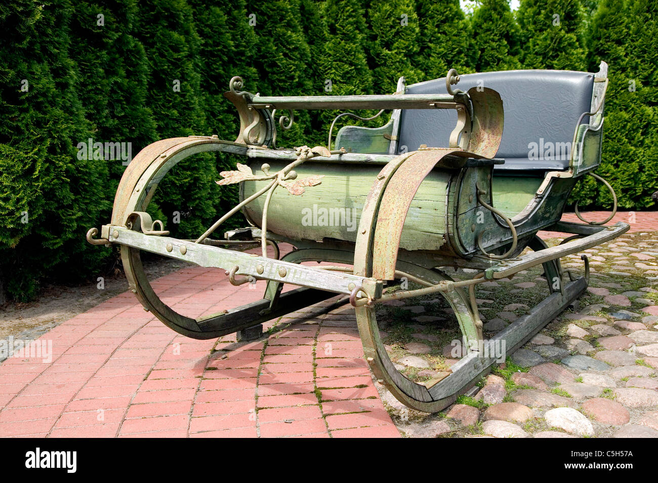 Old antique green sledge with metal skis with nature background Stock ...
