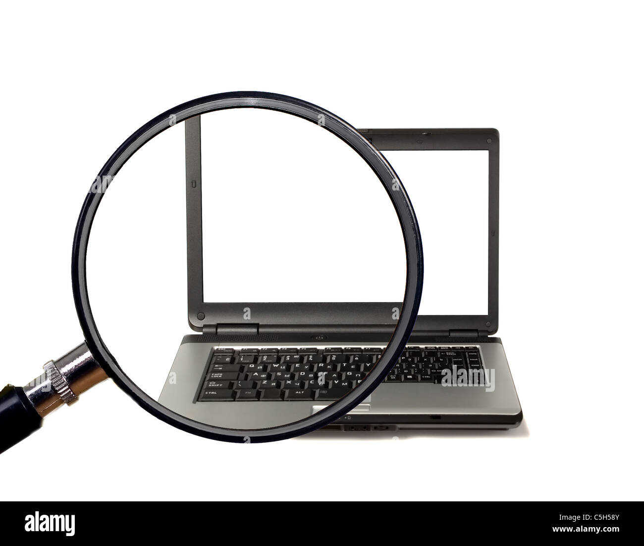 Magnifying glass magnifies laptop with white screen Stock Photo - Alamy