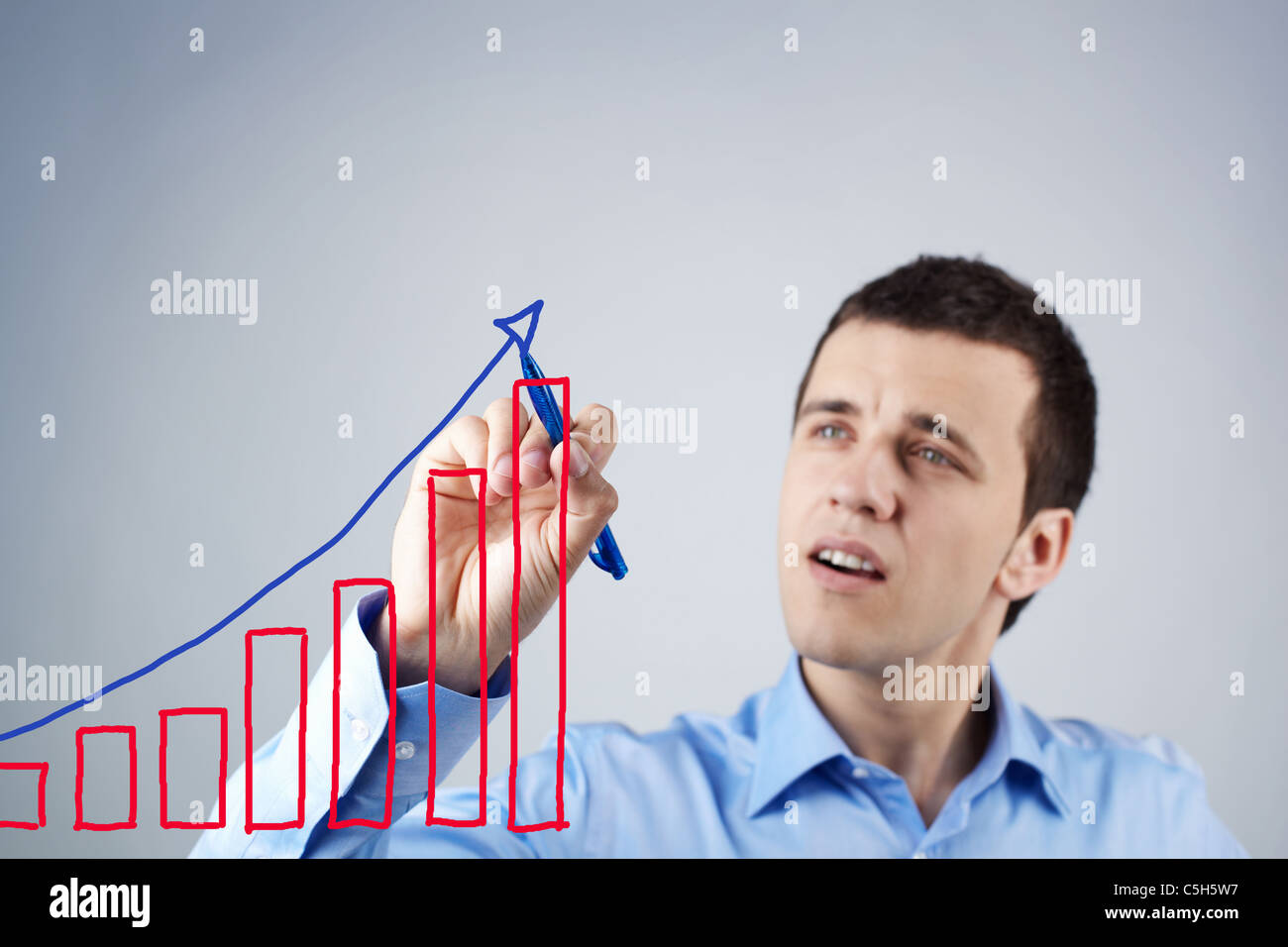 Confident businessman drawing success scheme Stock Photo - Alamy